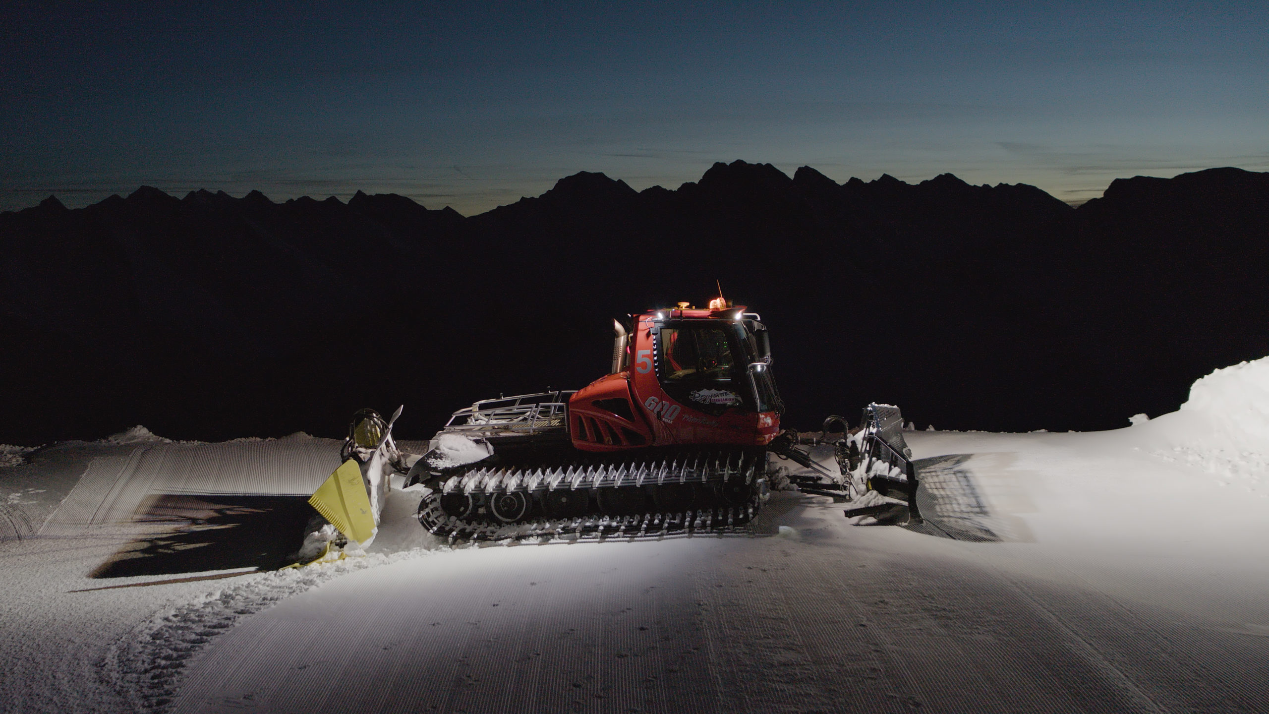 Piste machine at dawn | aerial-footage.com